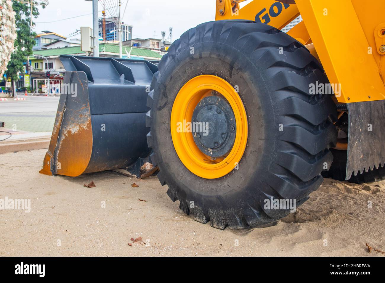 A yellow wheel loader at the beach Stock Photo - Alamy