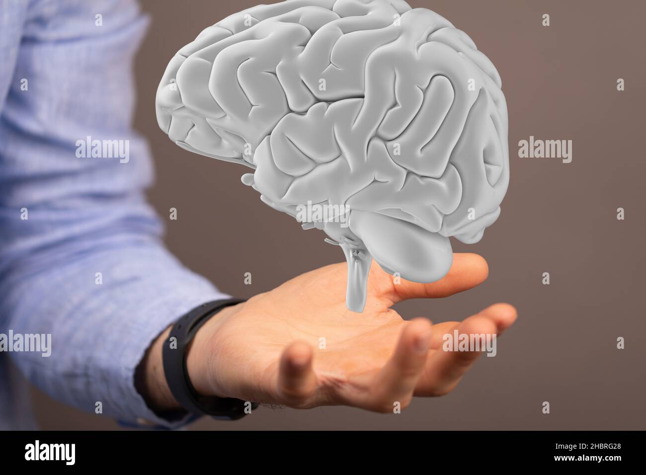 A male hand with a 3D rendered human brain over iy - innovation ...