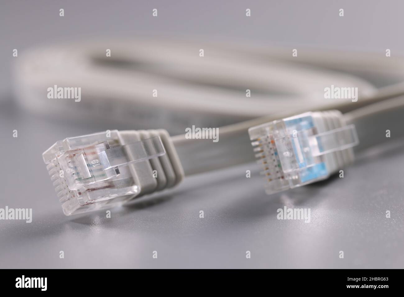 Pair of internet connectors on grey background, cable with plastic clip ...