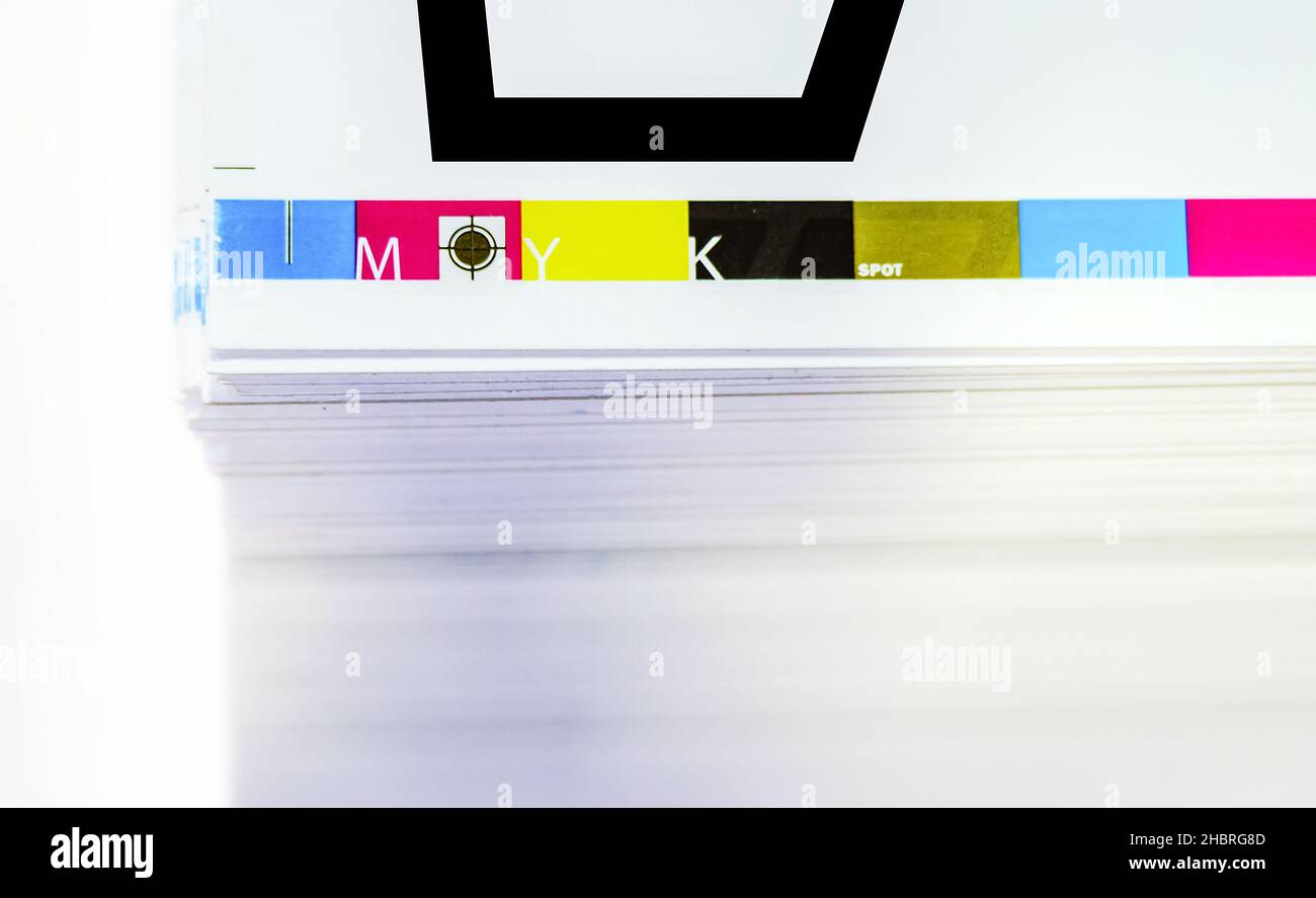 Offset printing. Sheets of printed products. CMYK press. Paper at the ...