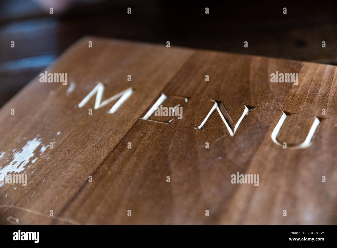 Wooden cover of the menu card with the inscription. Scratched and ...