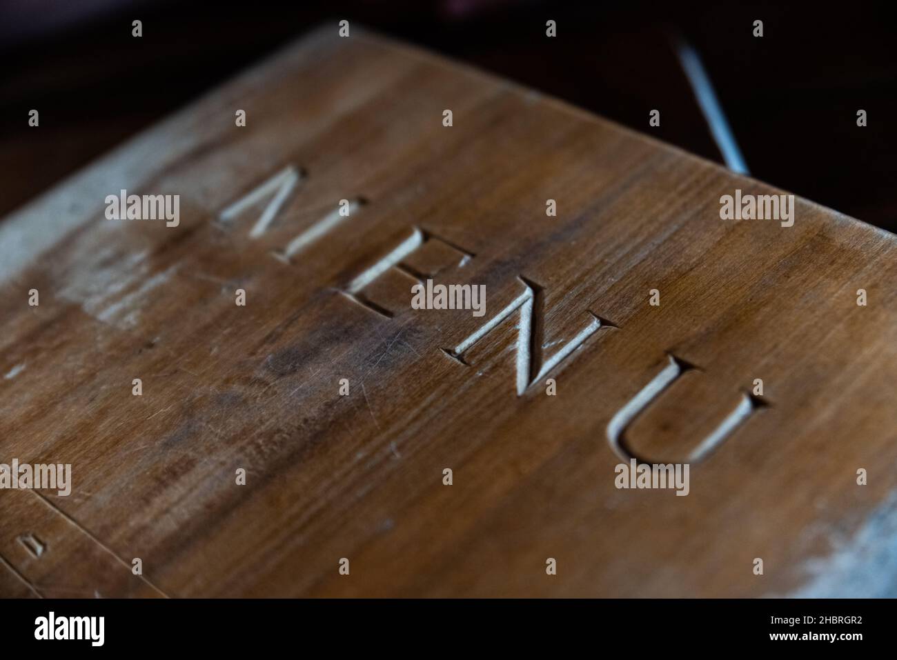 Wooden cover of the menu card with the inscription. Scratched and ...