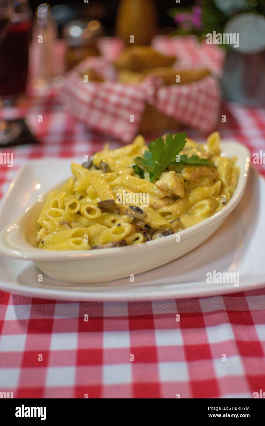A vertical closeup shot of delicious pasta with cheese and mushroom ...