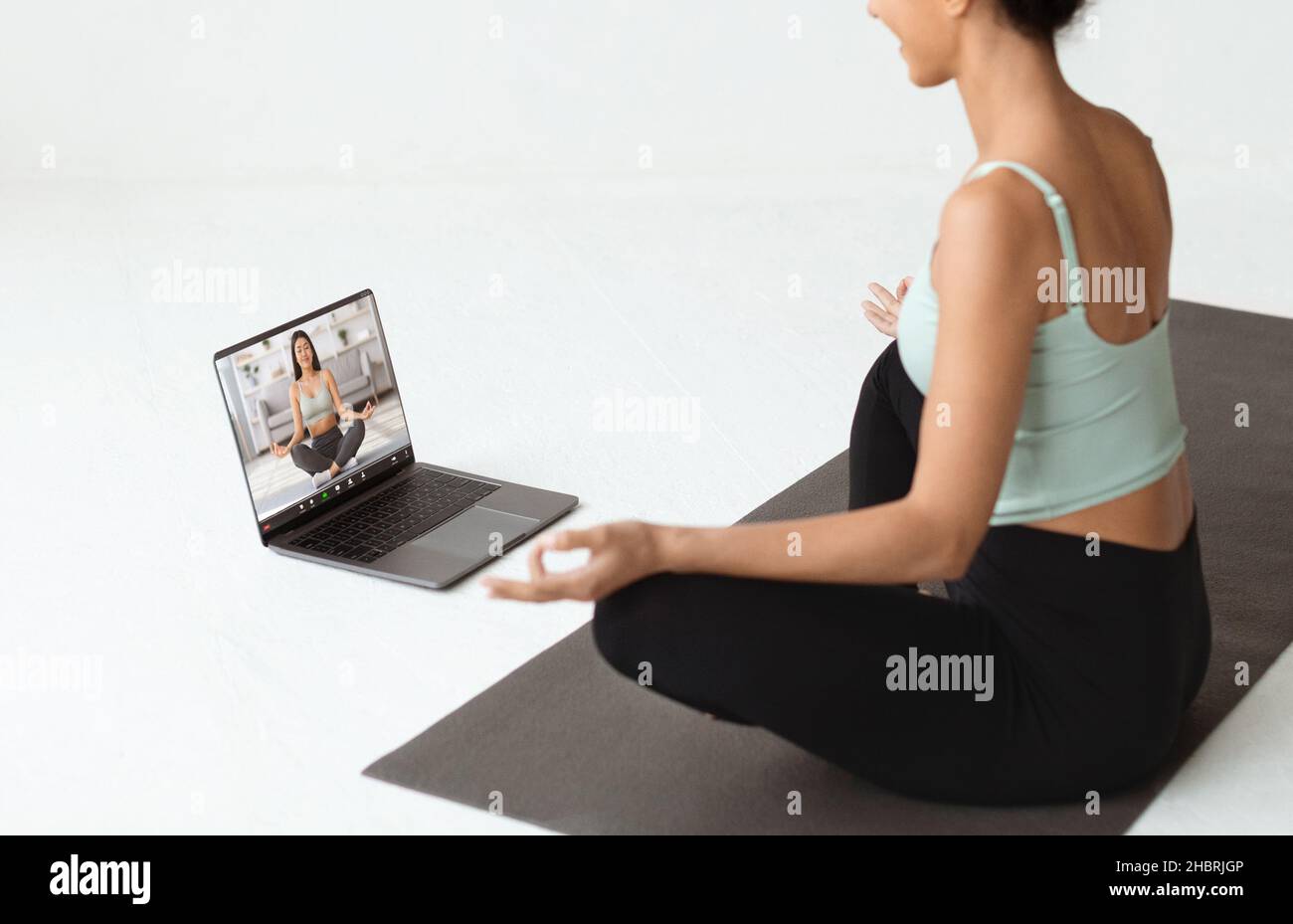 Virtual Yoga Class. Brunette Lady Meditating While Having Video Call ...