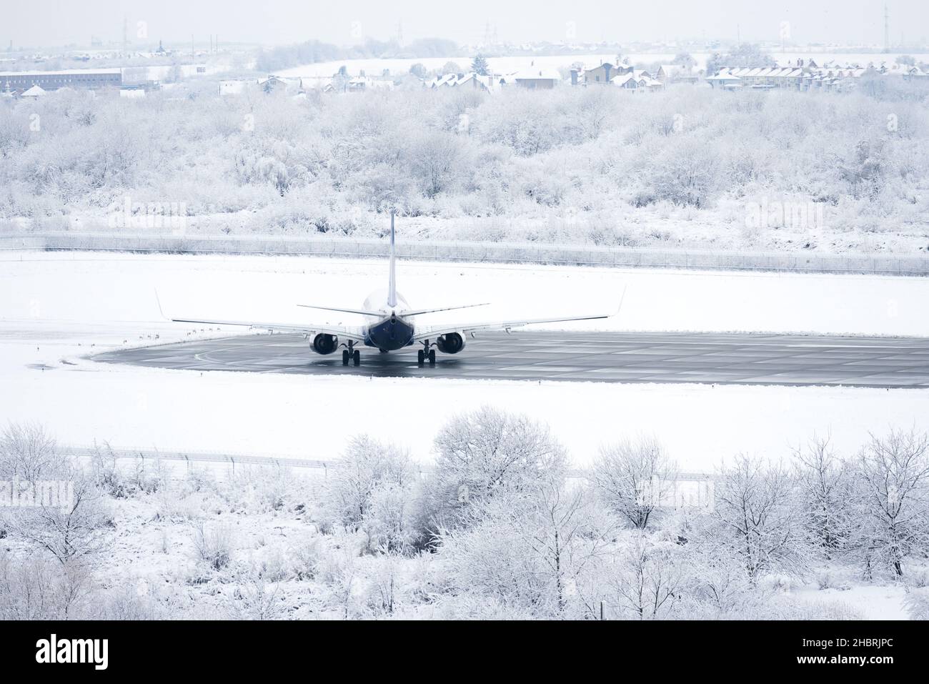Airplane is getting ready for flight. Airliner on runway in blizzard ...