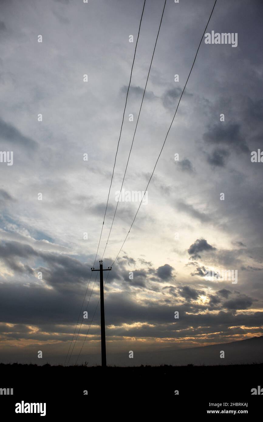 Electric pylon against dark sky hi-res stock photography and images - Alamy