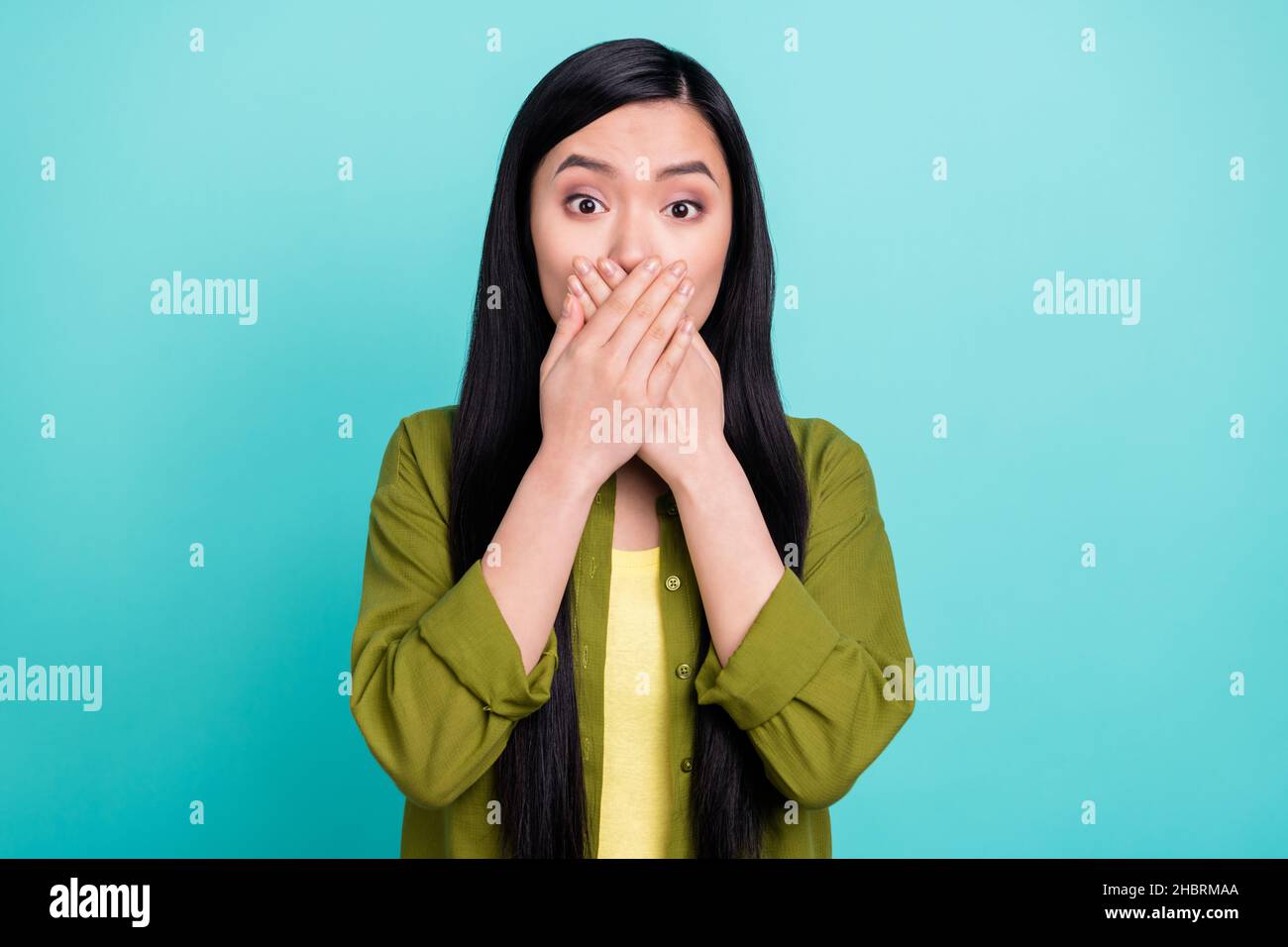 Photo of young asian girl cover lips hands oops fail tell speak secret ...