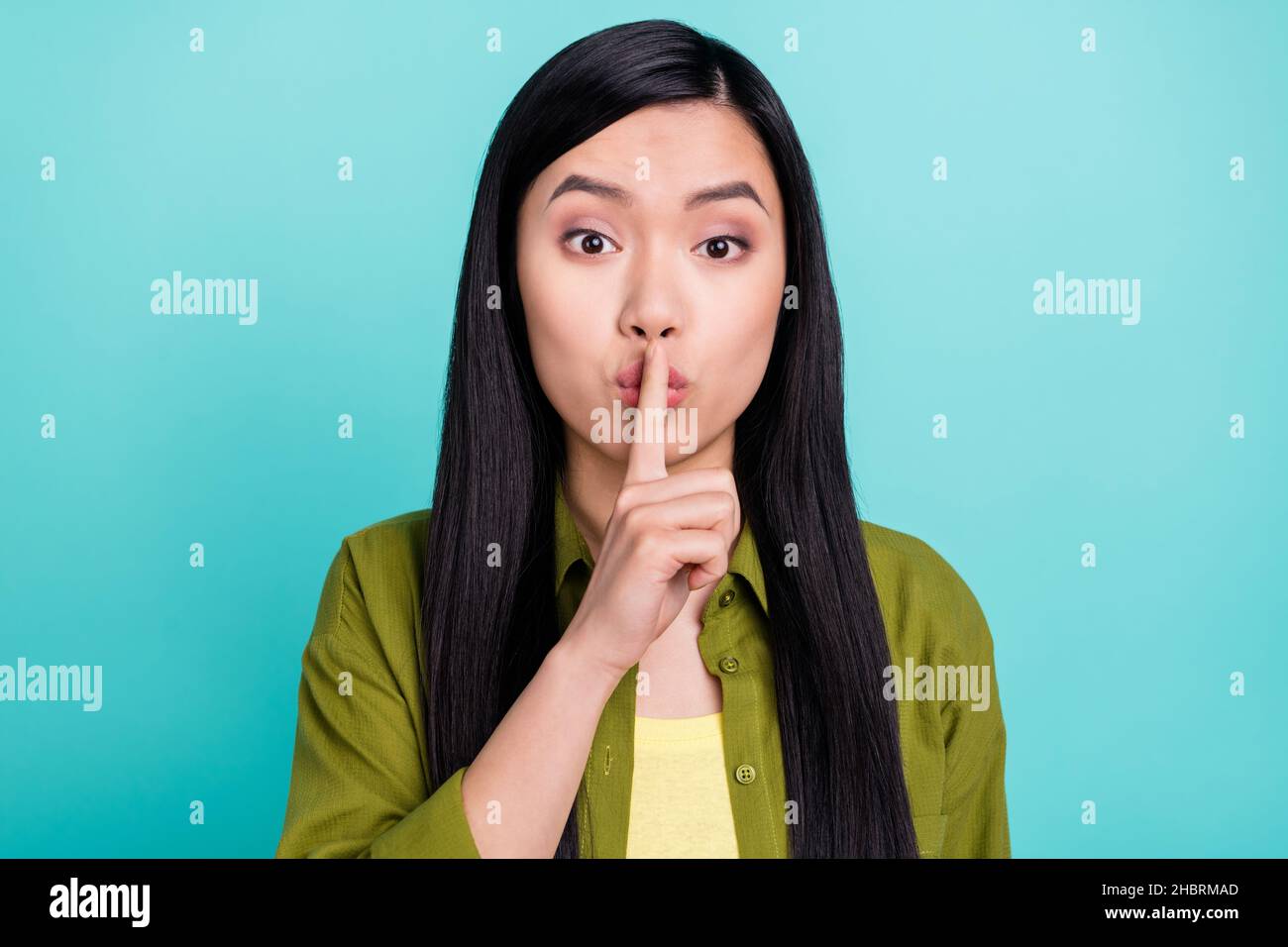 Photo of young asian girl finger touch lips shh keep secret ...