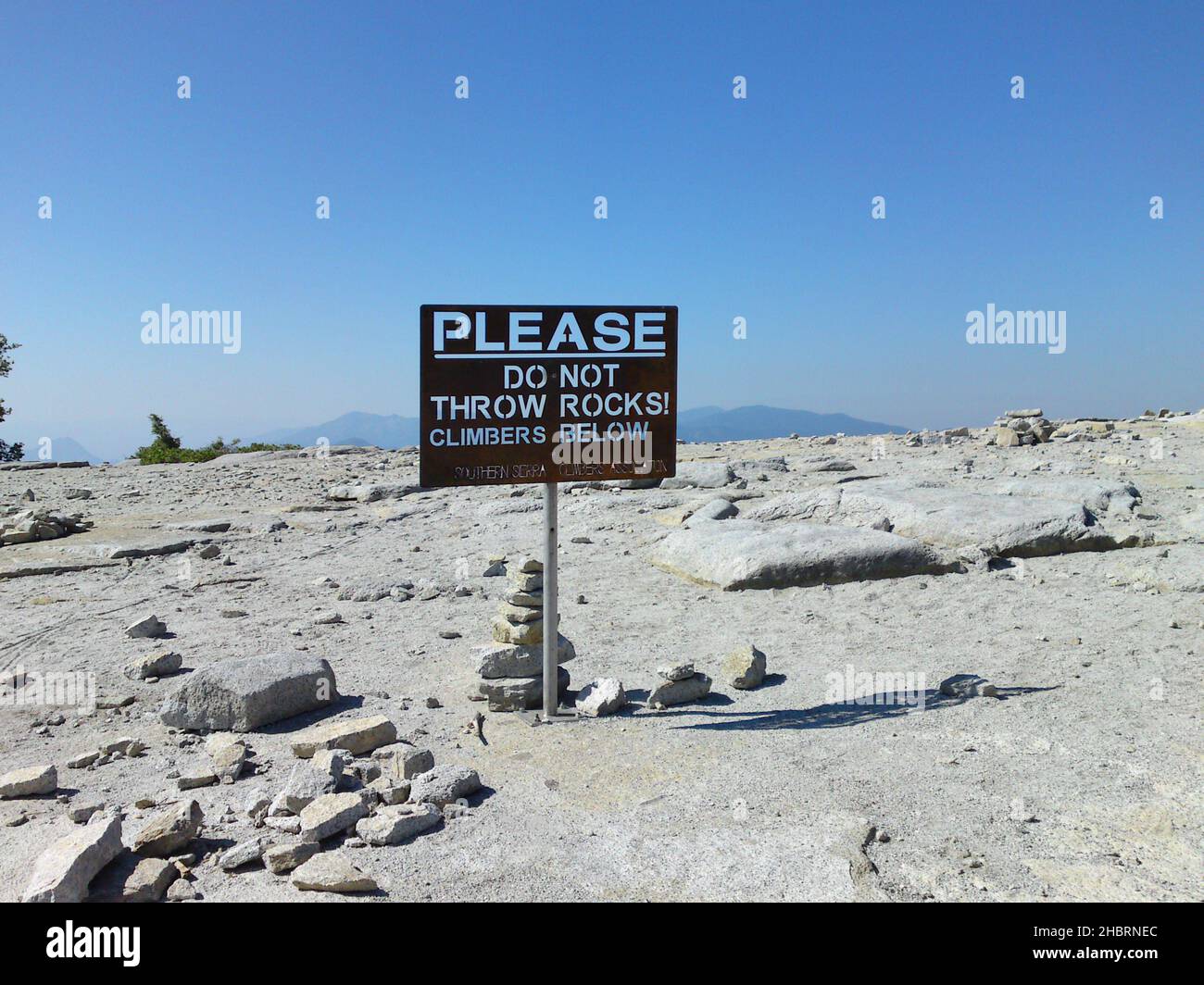 The warning sign surrounded by rocks Stock Photo - Alamy
