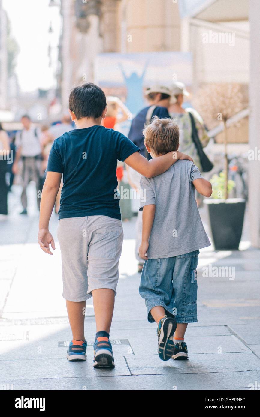 Two brothers or friends hugging each other walking and playing in the ...