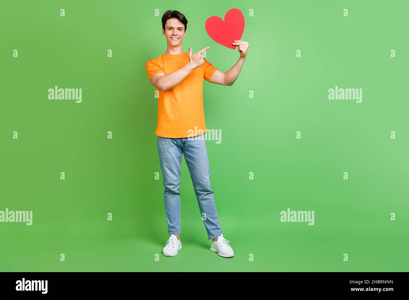 Full body photo of charming happy positive man point finger heart shape ...