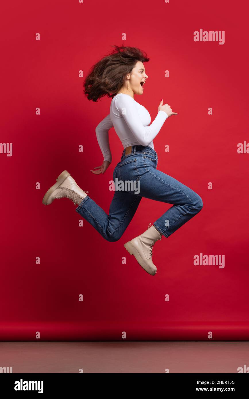 Dynamic portrait of excited young beautiful girl in casual clothes ...