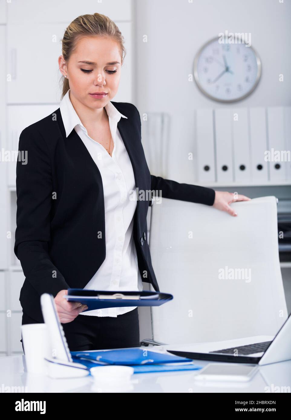 Business woman standing in office Stock Photo - Alamy
