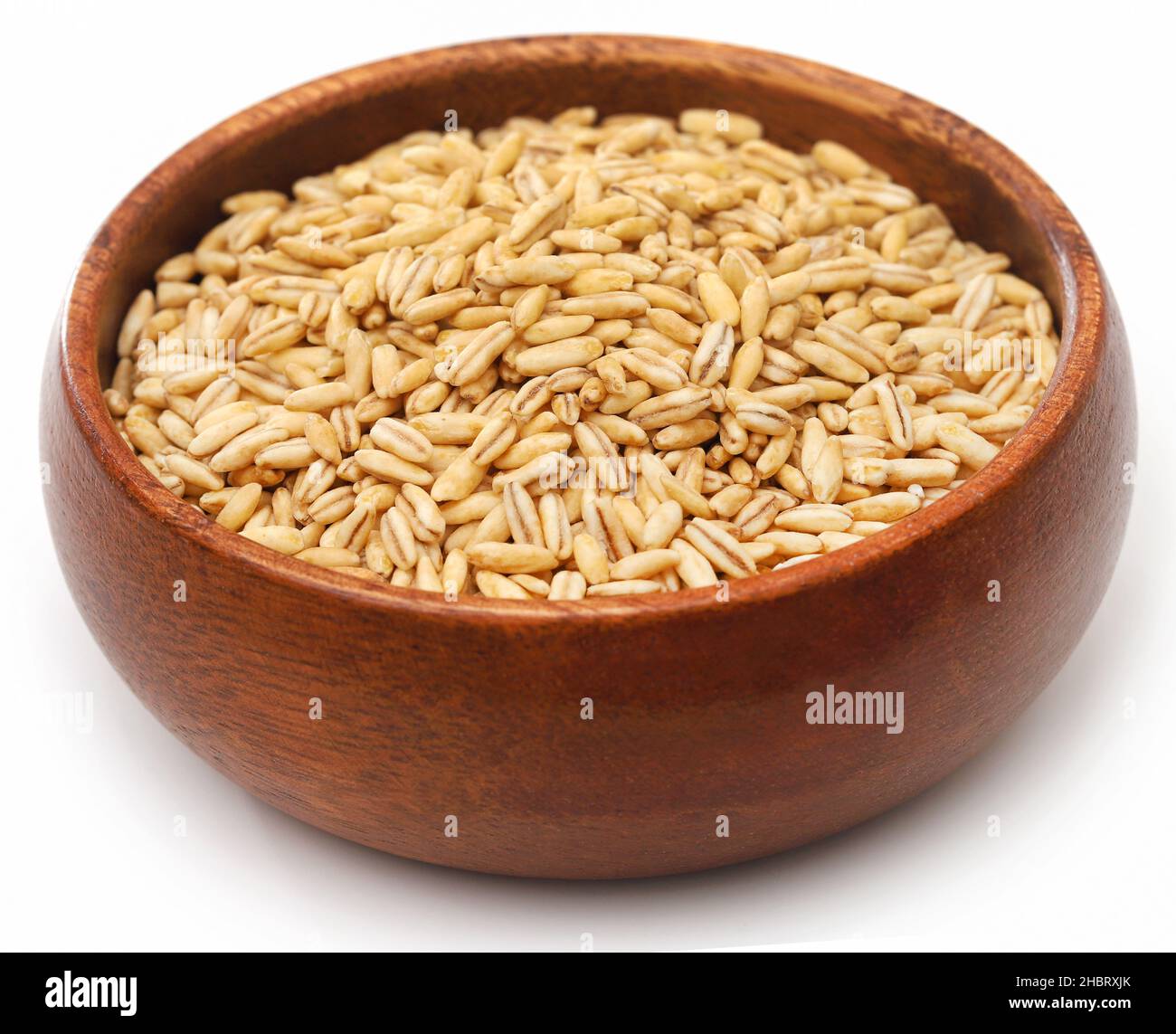 Whole oats in a bowl over white background Stock Photo - Alamy