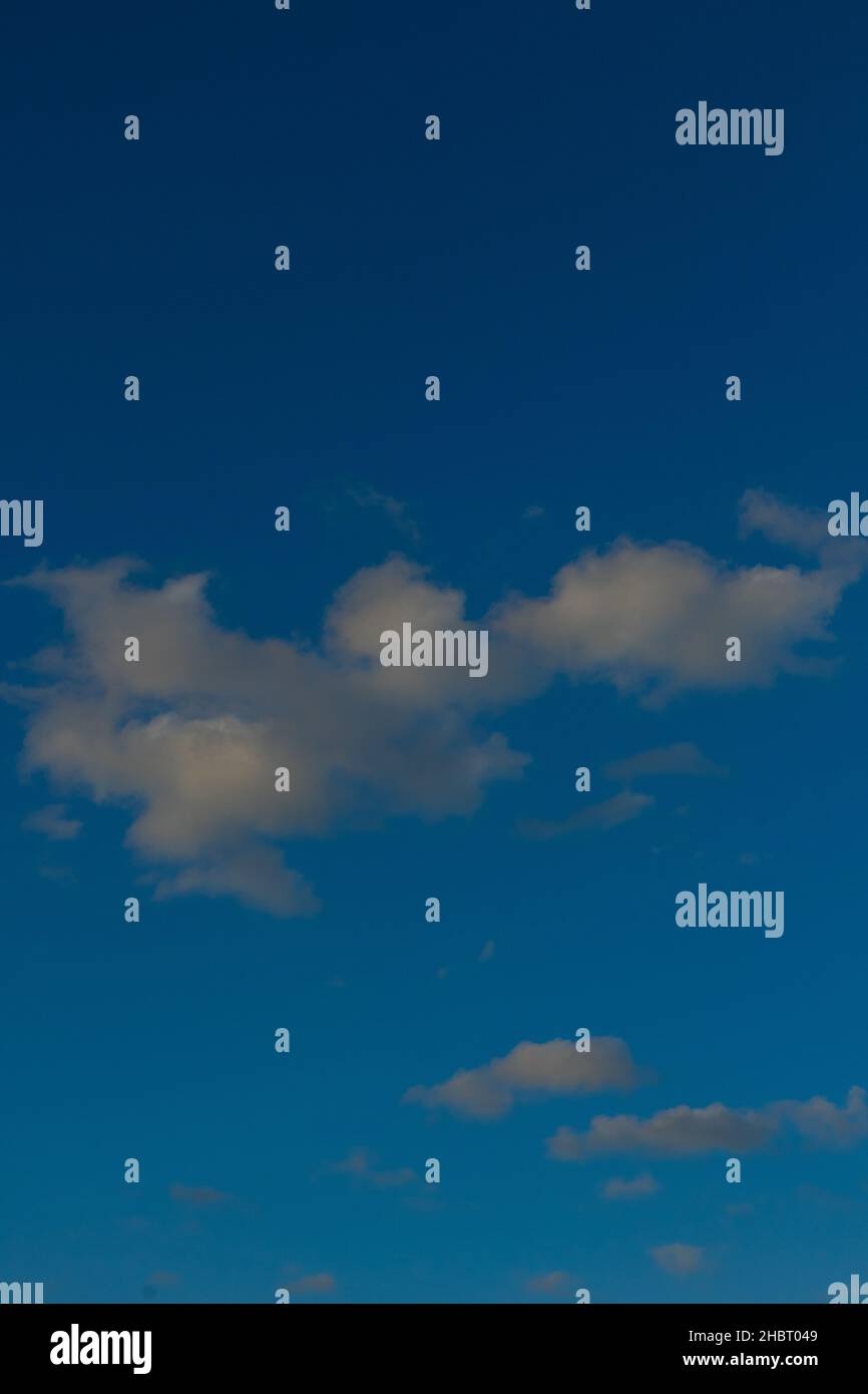 Pattern of clouds forming in blue sky creating an abstract background ...