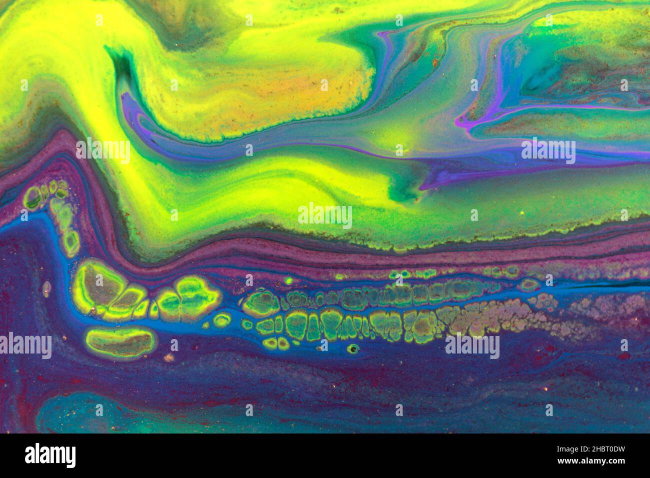 Yellow ink drops in mix blue paint background Stock Photo - Alamy