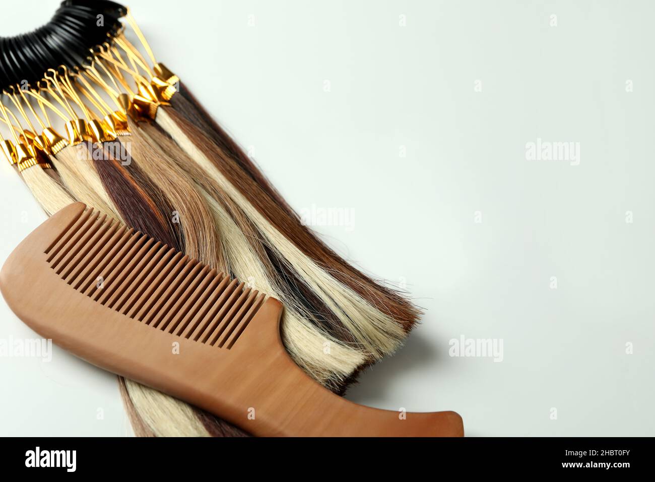Hair samples and hairbrush on white background Stock Photo - Alamy