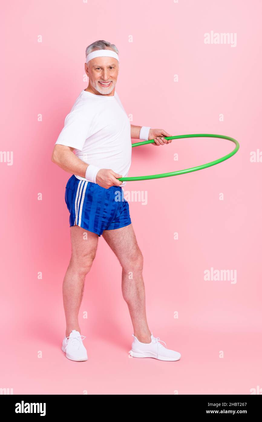Full length body size photo man keeping hoola hoop training in gym ...