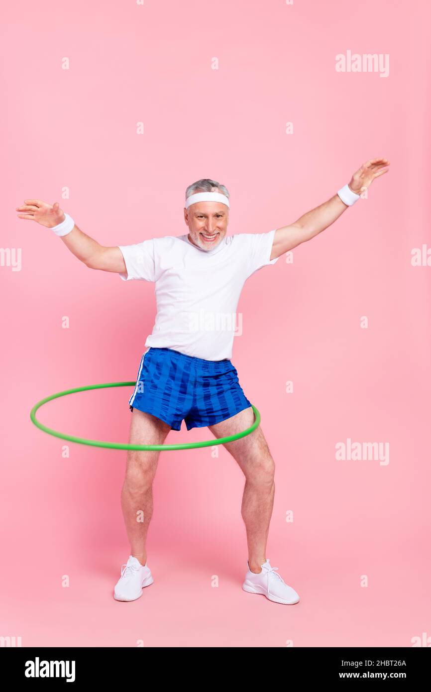 Full length body size photo man keeping hoola hoop training in gym ...