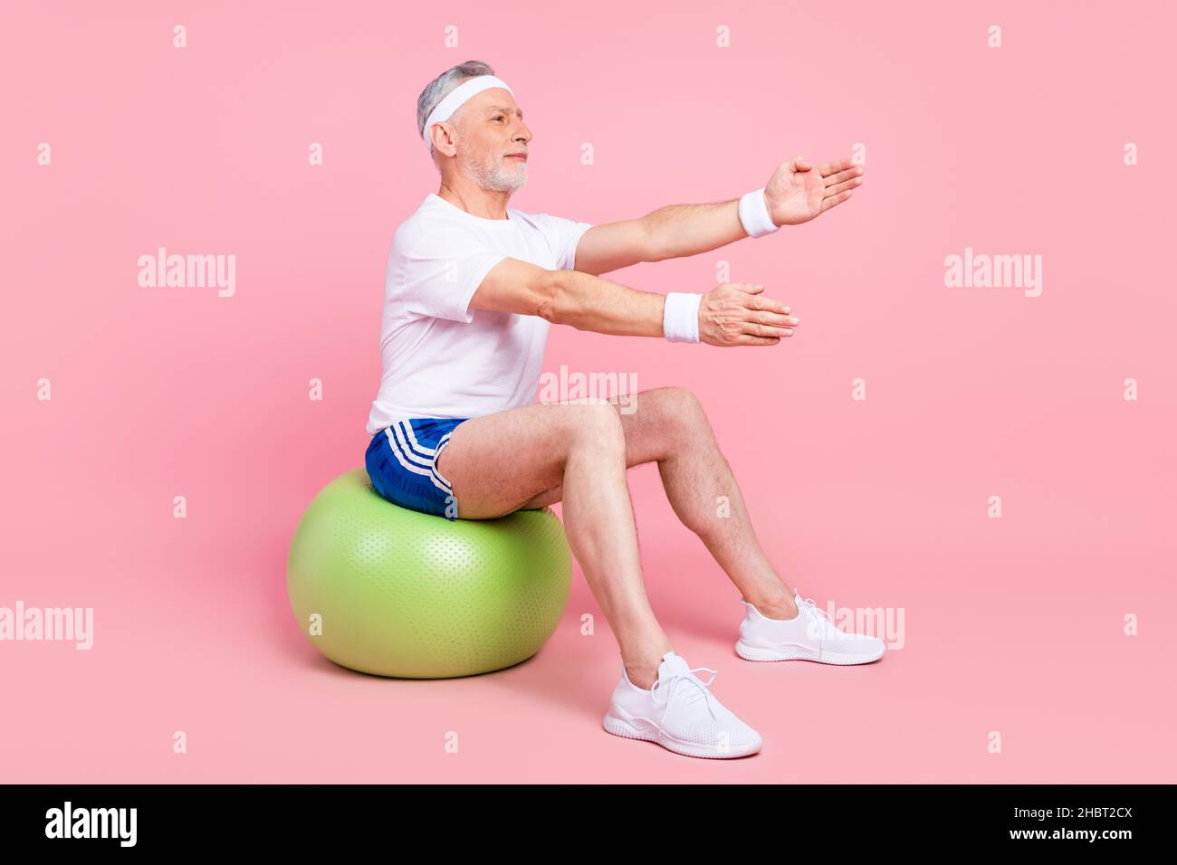 Full length body size photo man sitting fit ball doing exercises in gym ...