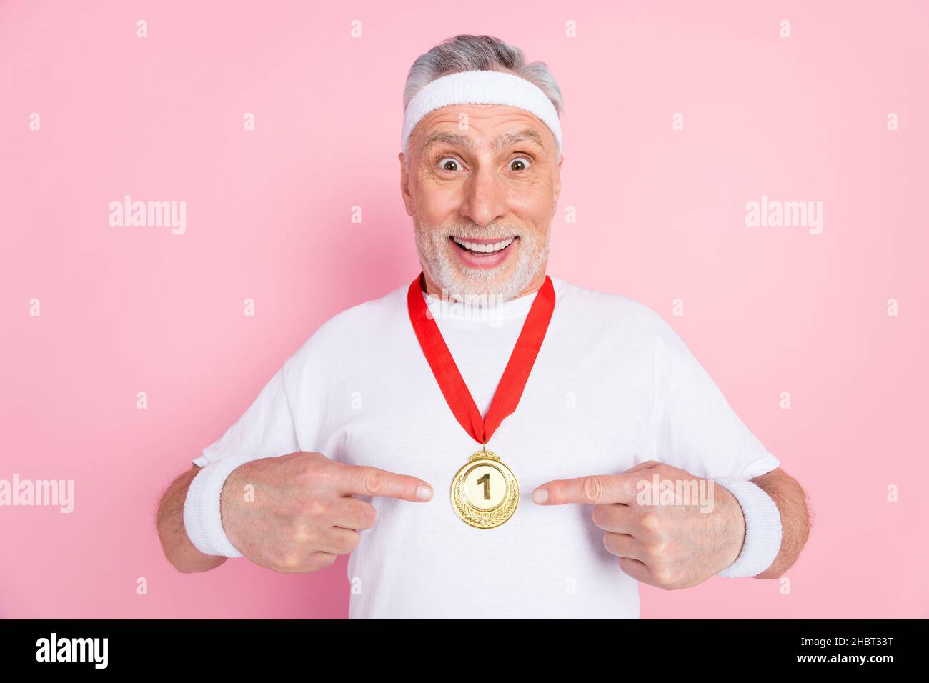 Photo of crazy sporty grandpa point medal wear white t-shirt isolated ...