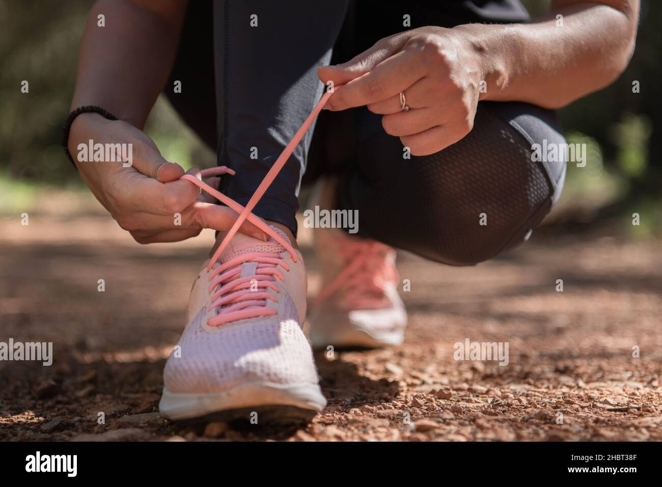 Female athlete tying shoelace hi-res stock photography and images - Alamy