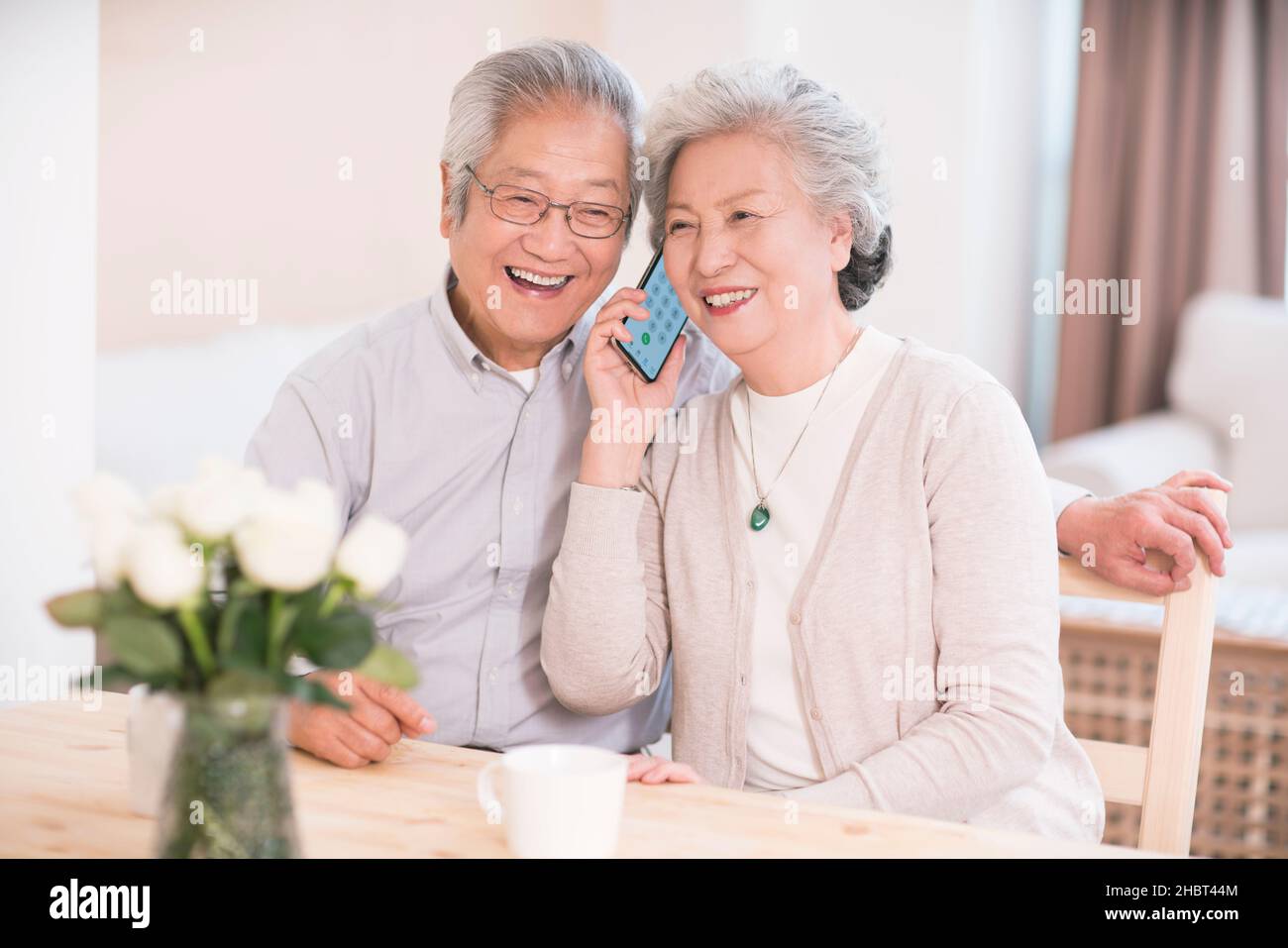 Elderly couple calling at home Stock Photo - Alamy
