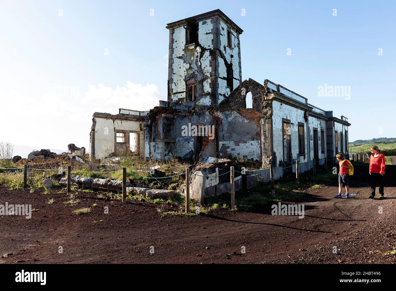 Mother and son walking at ruins of Ribeirinha Lighthouse, Faial Island ...