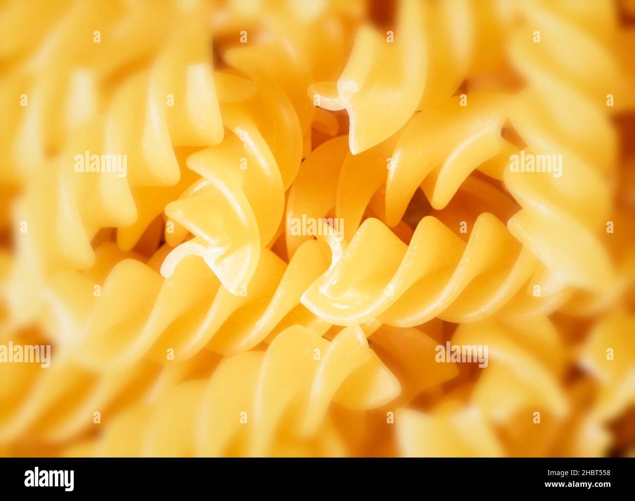 Macro food still life of Fusilli, fuˈzilli, pasta on plain background ...