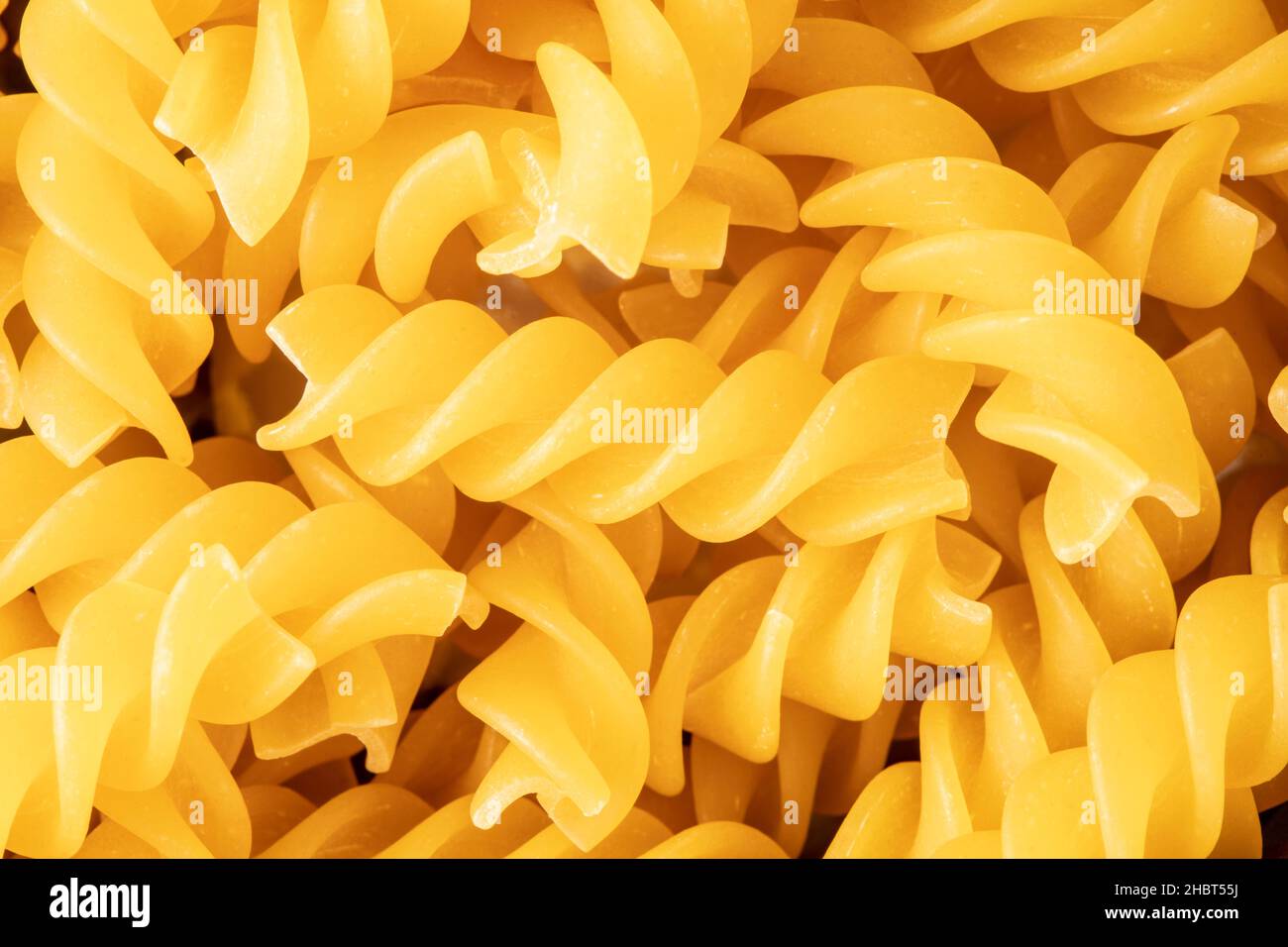 Macro food still life of Fusilli, fuˈzilli, pasta on plain background ...