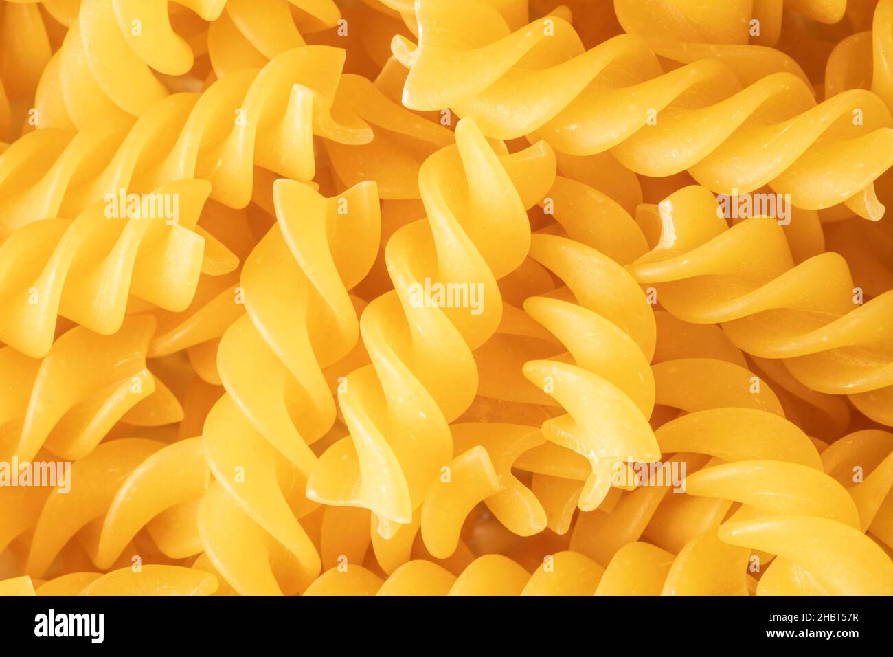 Macro food still life of Fusilli, fuˈzilli, pasta on plain background ...