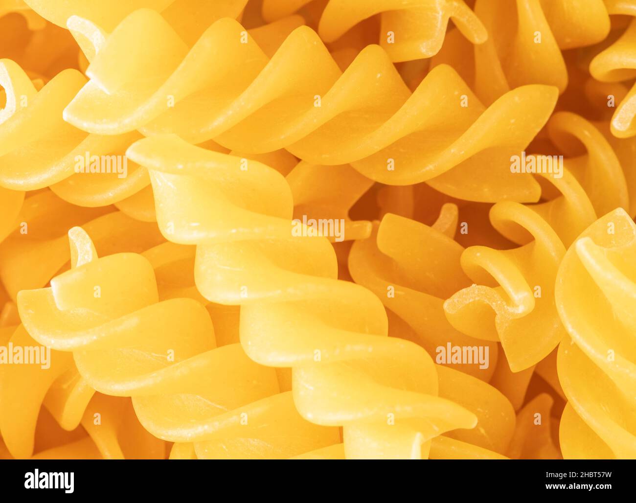 Macro food still life of Fusilli, fuˈzilli, pasta on plain background ...