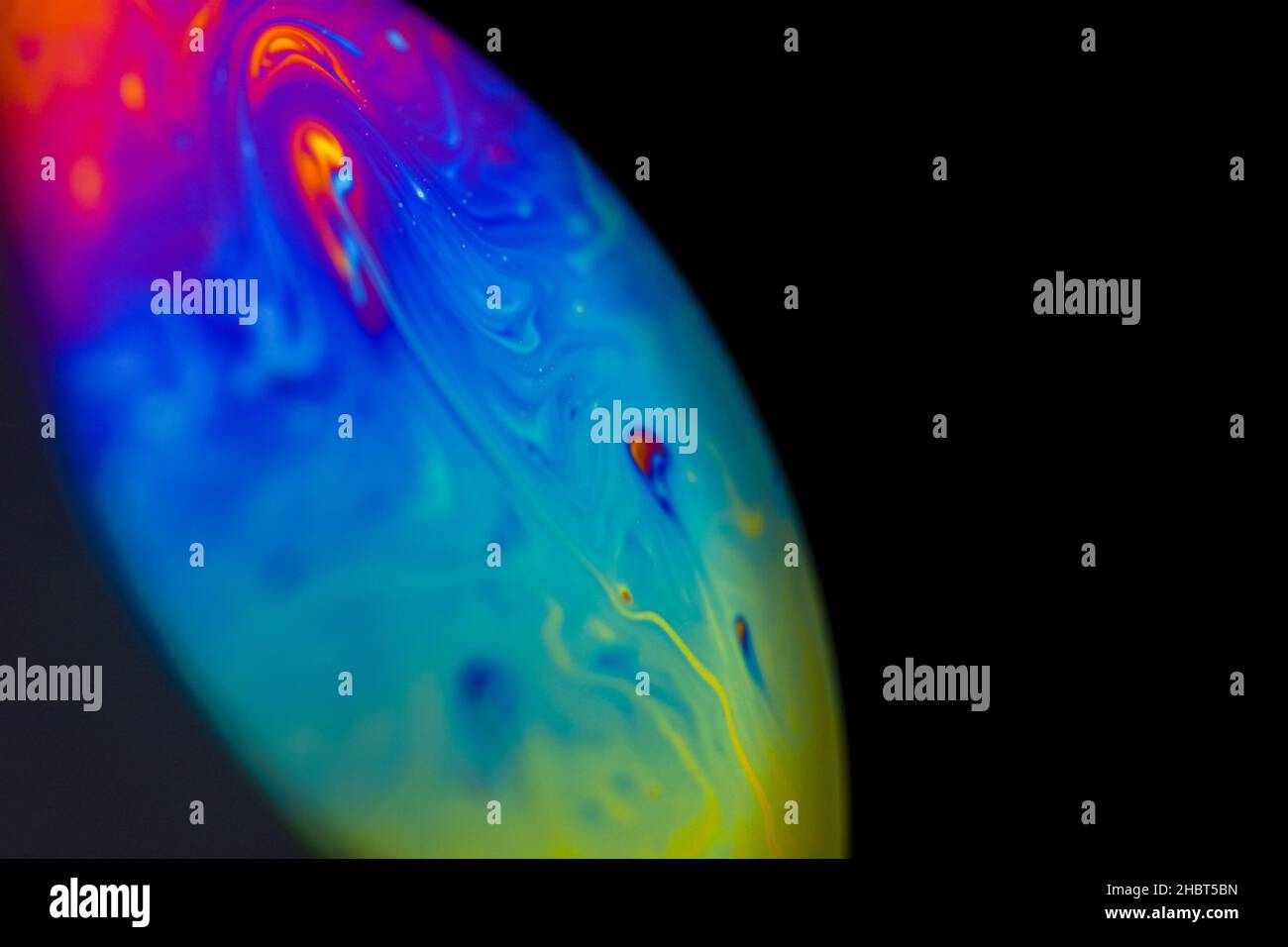 Abstract multicolor psychedelic planet in universe. Closeup soap bubble ...