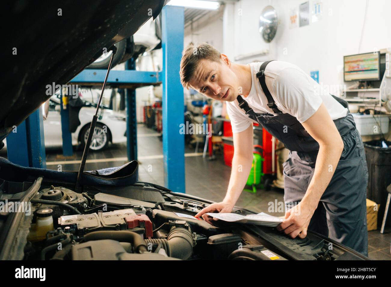 Front view of professional handsome professional male car mechanic in ...