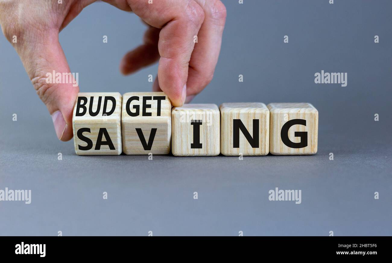 Budgeting and saving symbol. Businessman turns wooden cubes and changes ...