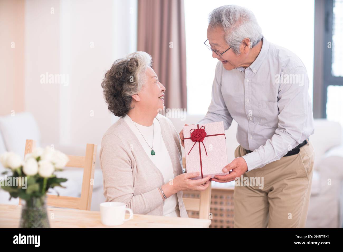 Old man sending gifts to his wife Stock Photo - Alamy