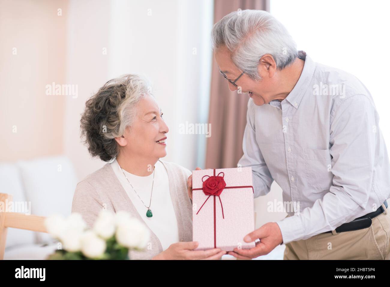 Old man sending gifts to his wife Stock Photo - Alamy