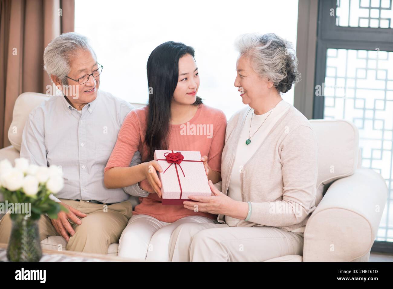 Daughter giving parents gifts Stock Photo - Alamy