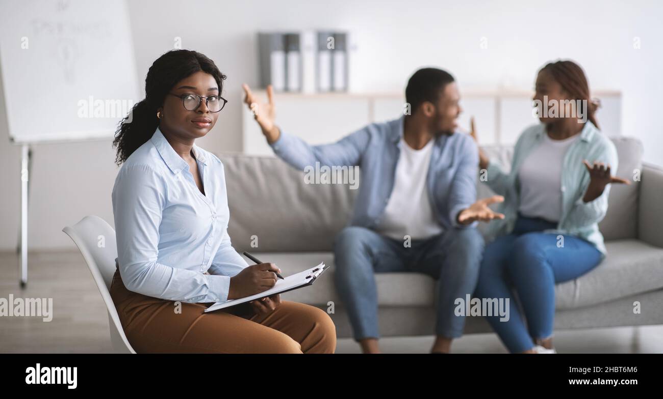 Unhappy female psychologist and black married couple having fight ...