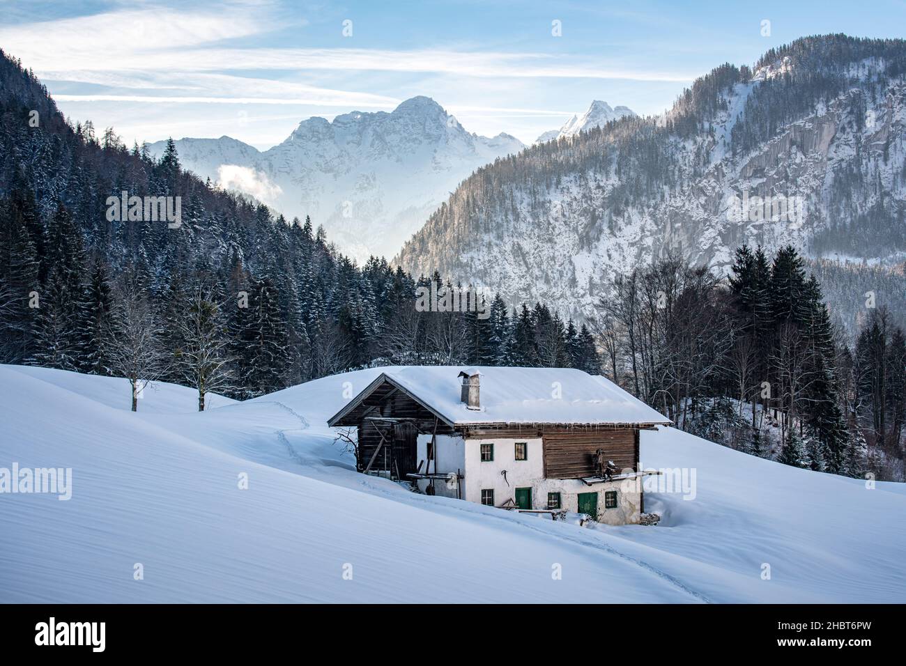 Traditional austrian farmhouse in an idyllic winter landscape ...