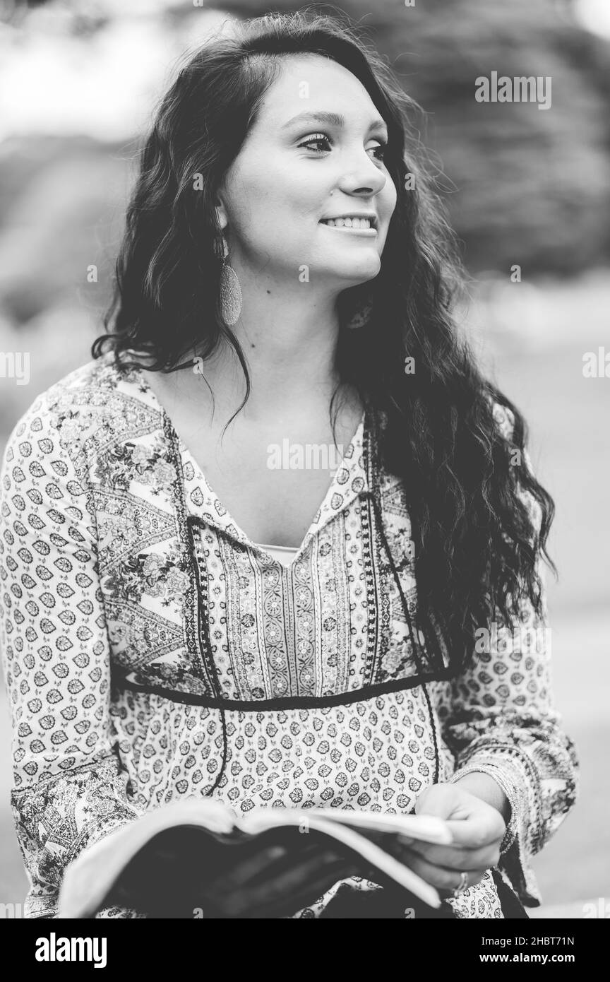 A grayscale portrait of a beautiful American lady with a book Stock ...