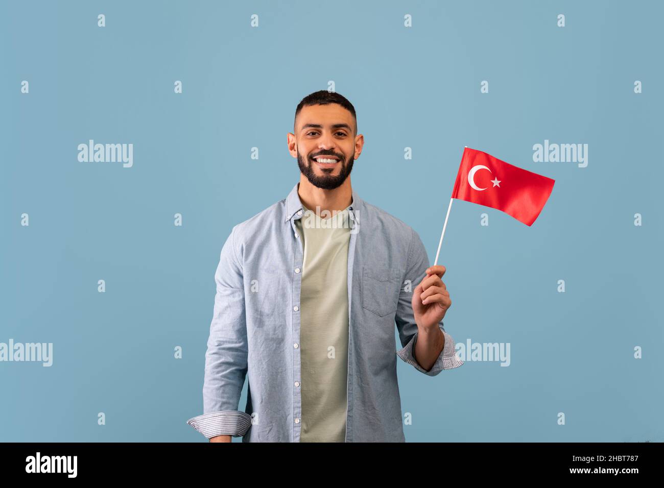 Language study and exchange student. Excited middle eastern man holding ... Language study and exchange student. Excited middle eastern man holding ...