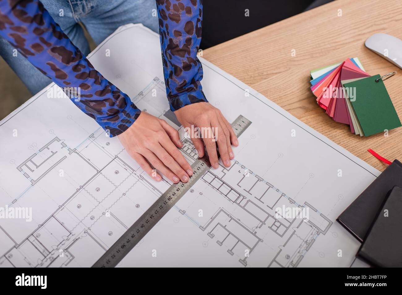 top view of interior designer holding ruler while working with ...