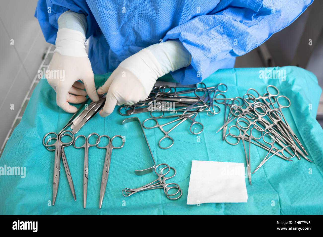 Multiple surgery instruments on blue table above view. surgeon take ...