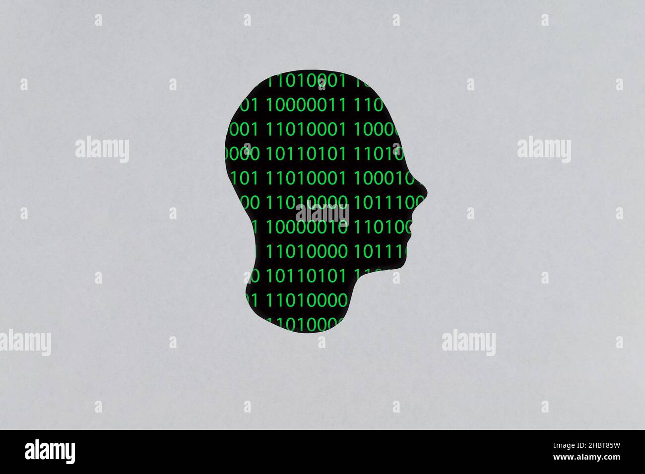 Silhouette of a human cardboard head cutout with a binary code made up ...