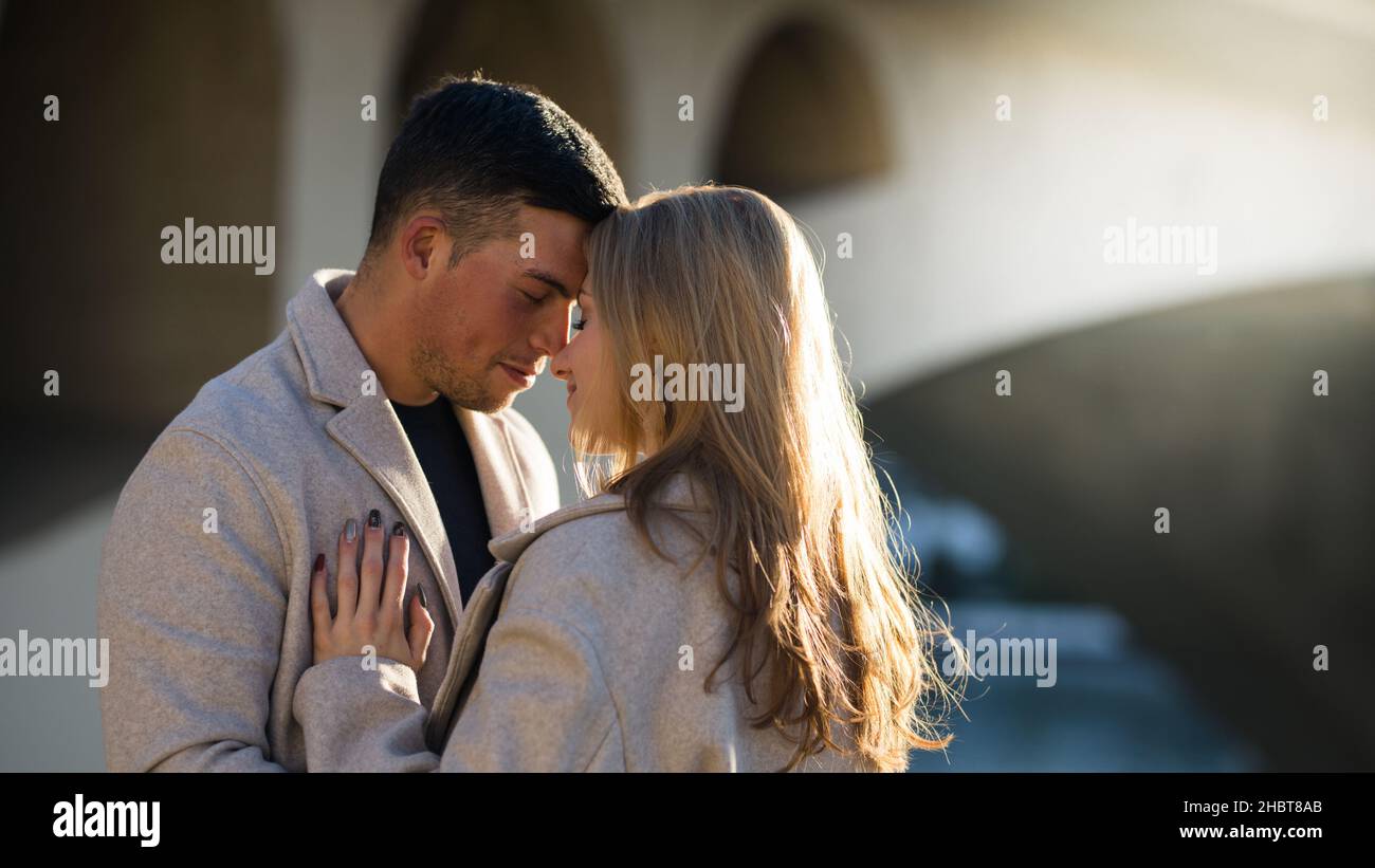 Young couple in love lean their heads to each other at sunset Stock ...