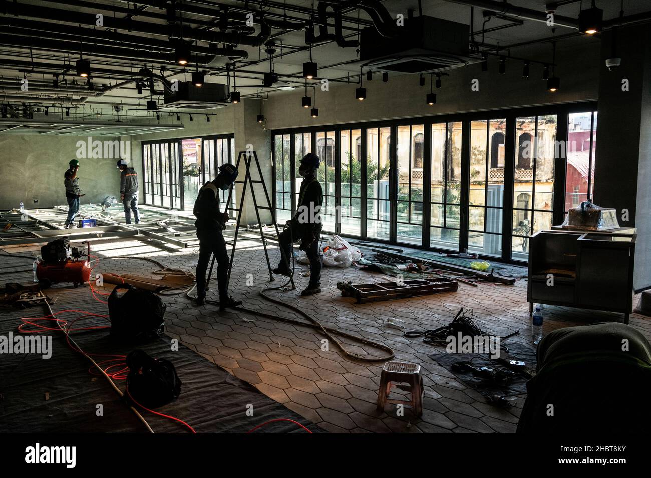 construction industry workers working inside modern building site in ho ...