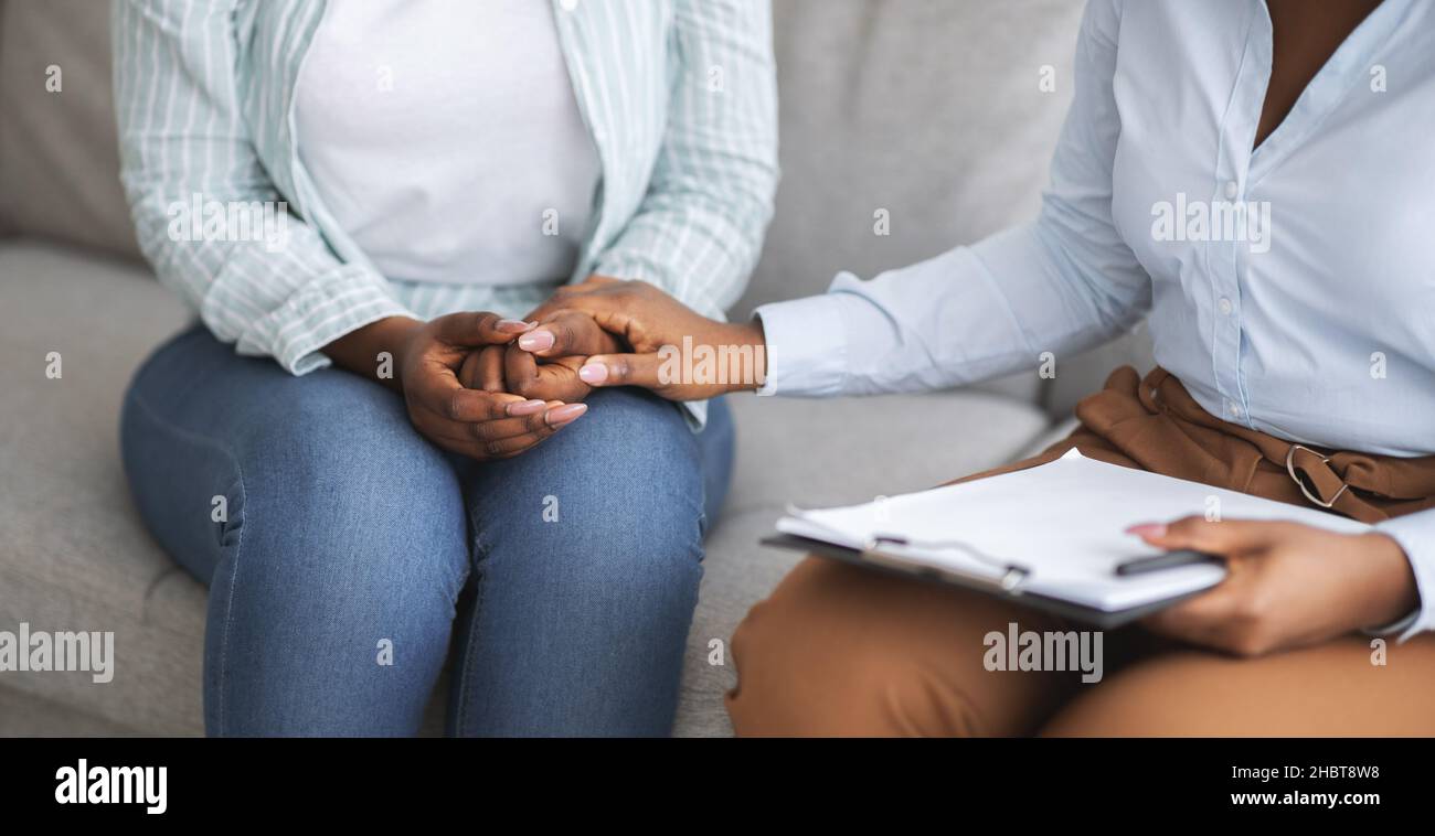 Therapist providing psychological assistance to female patient, holding ...