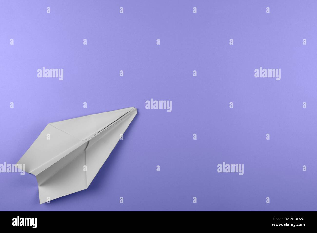 Flat lay of color paper plane colored in trendy violet color Stock ...