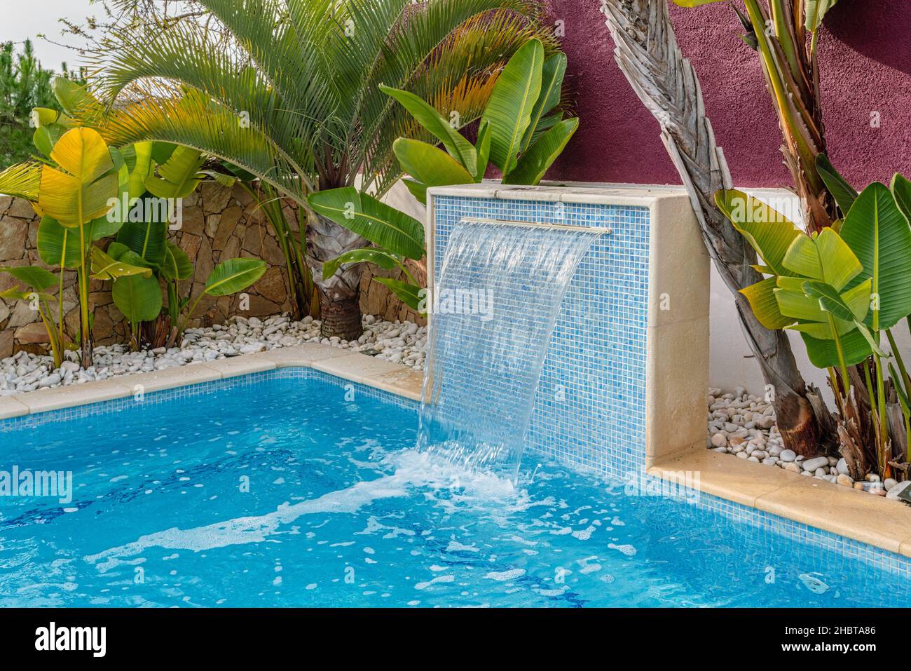Swimming pool waterfall garden hi-res stock photography and images - Alamy